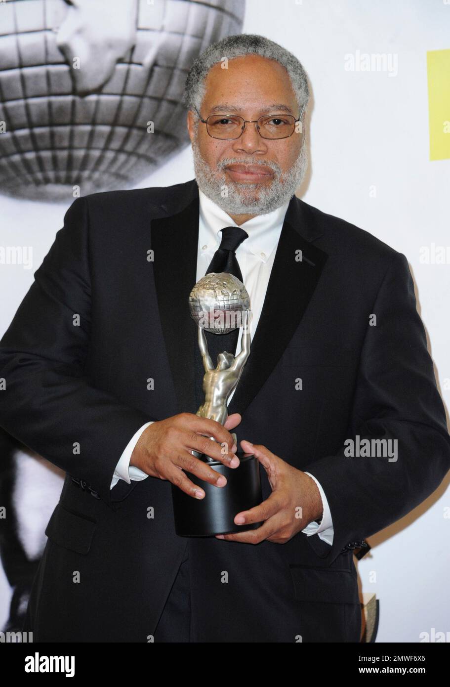 Dr. Lonnie G. Bunch III poses with the president's award in the press ...