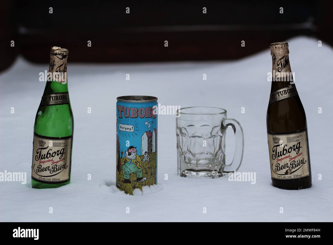 Two beer bottles and one beer can featuring a cartoon with a mug Stock ...