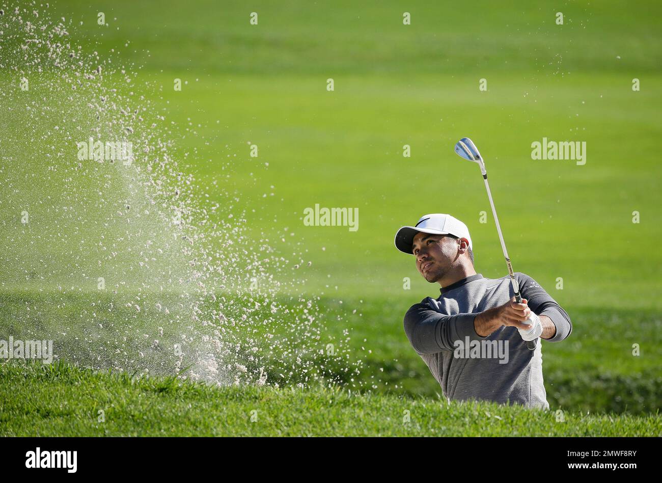 Jason Day, of Australia, follows his shot out of a bunker up to the ...