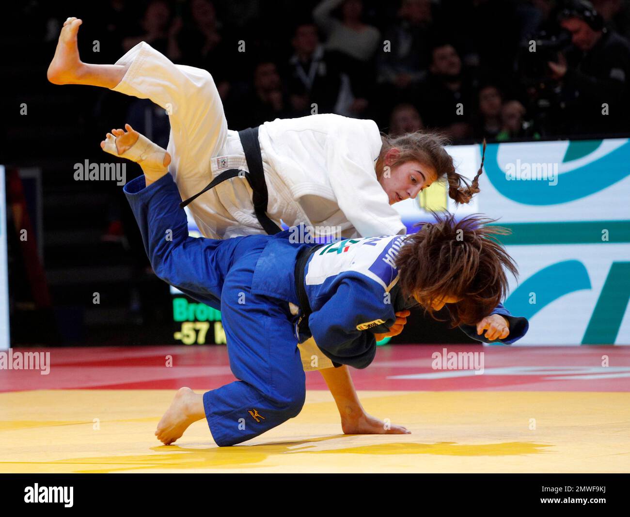 Tsukasa Yoshida of Japa, above, competes against Nora Gjakova of Kosovo ...