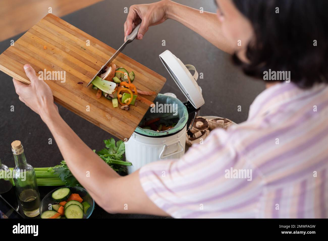 Biracial man cleaning waste in kitchen Stock Photo - Alamy