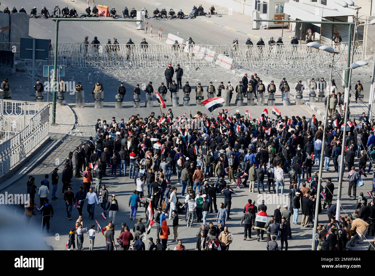 Iraqi riot police close a bridge leading to the heavily guarded Green ...