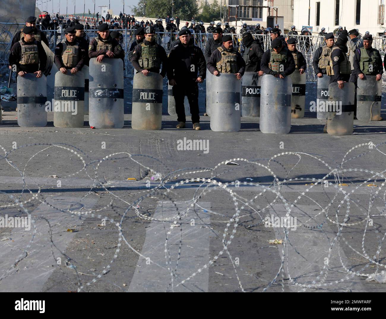 Iraqi riot police close a bridge leading to the heavily guarded Green ...