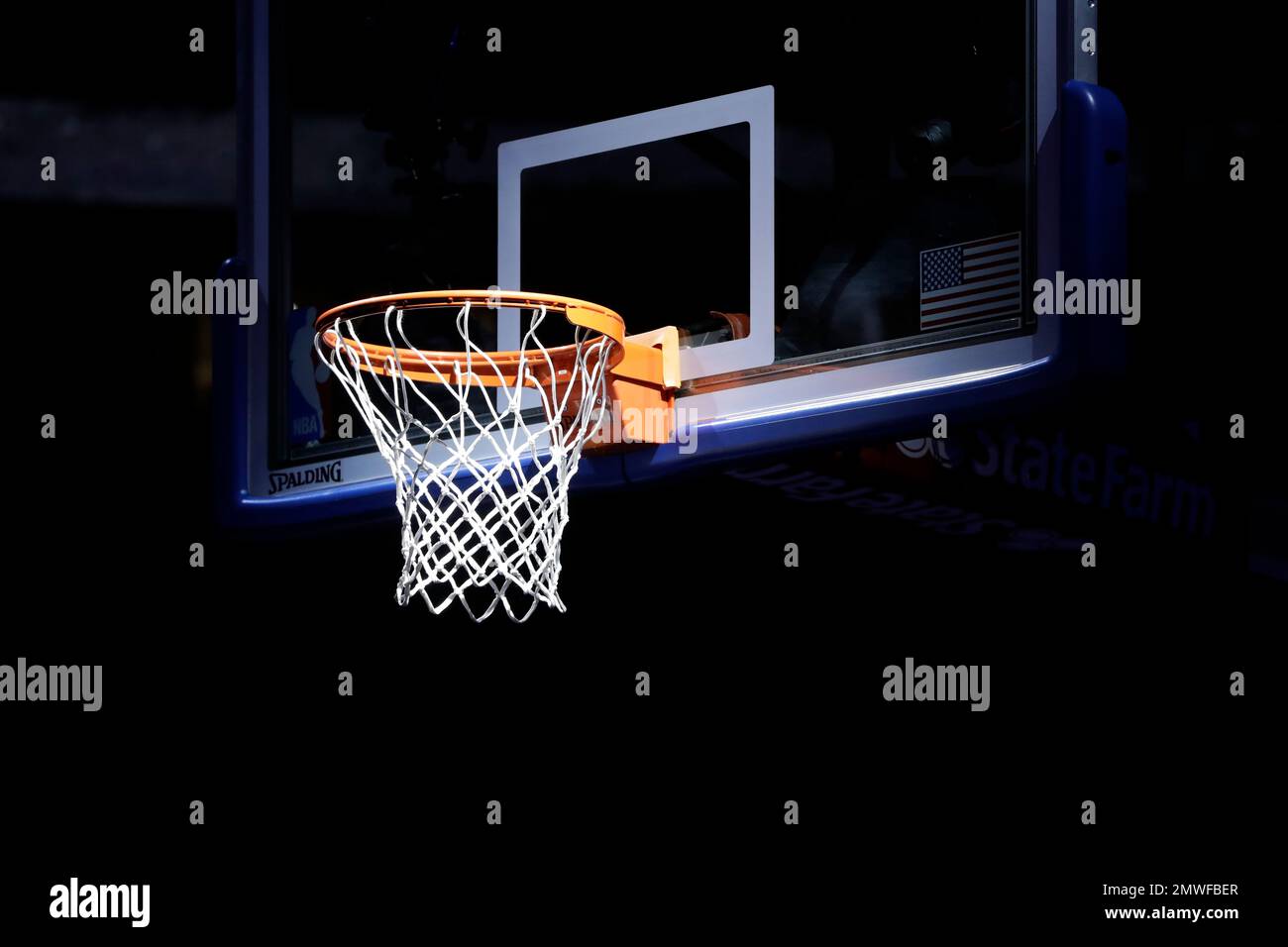 An NBA basketball backboard is illuminated during a halftime ceremony ...