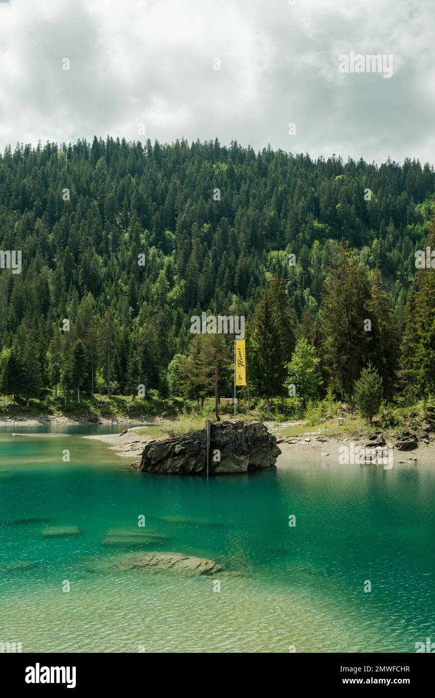A vertical shot of the Caumasee lake under a cloudy sky near Flims, in ...