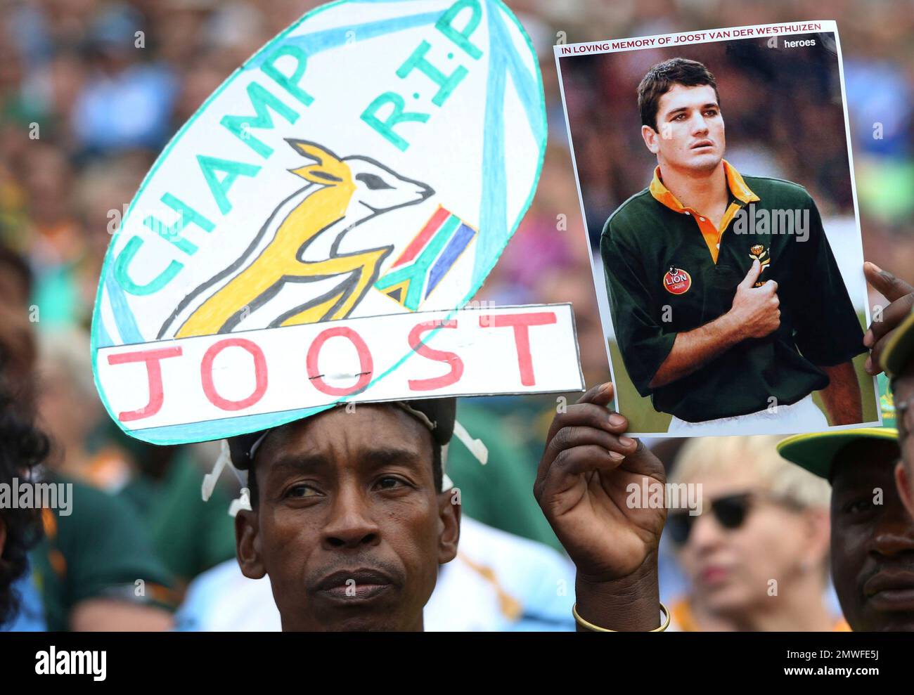 A mourner attends the memorial service for South African rugby legend ...