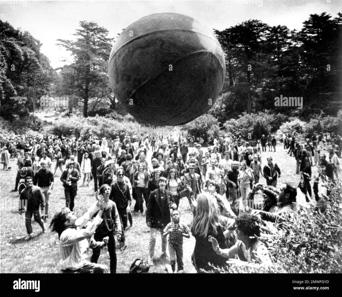 FILE - In this June 21, 1967, file photo, a crowd of hippies keep a ...