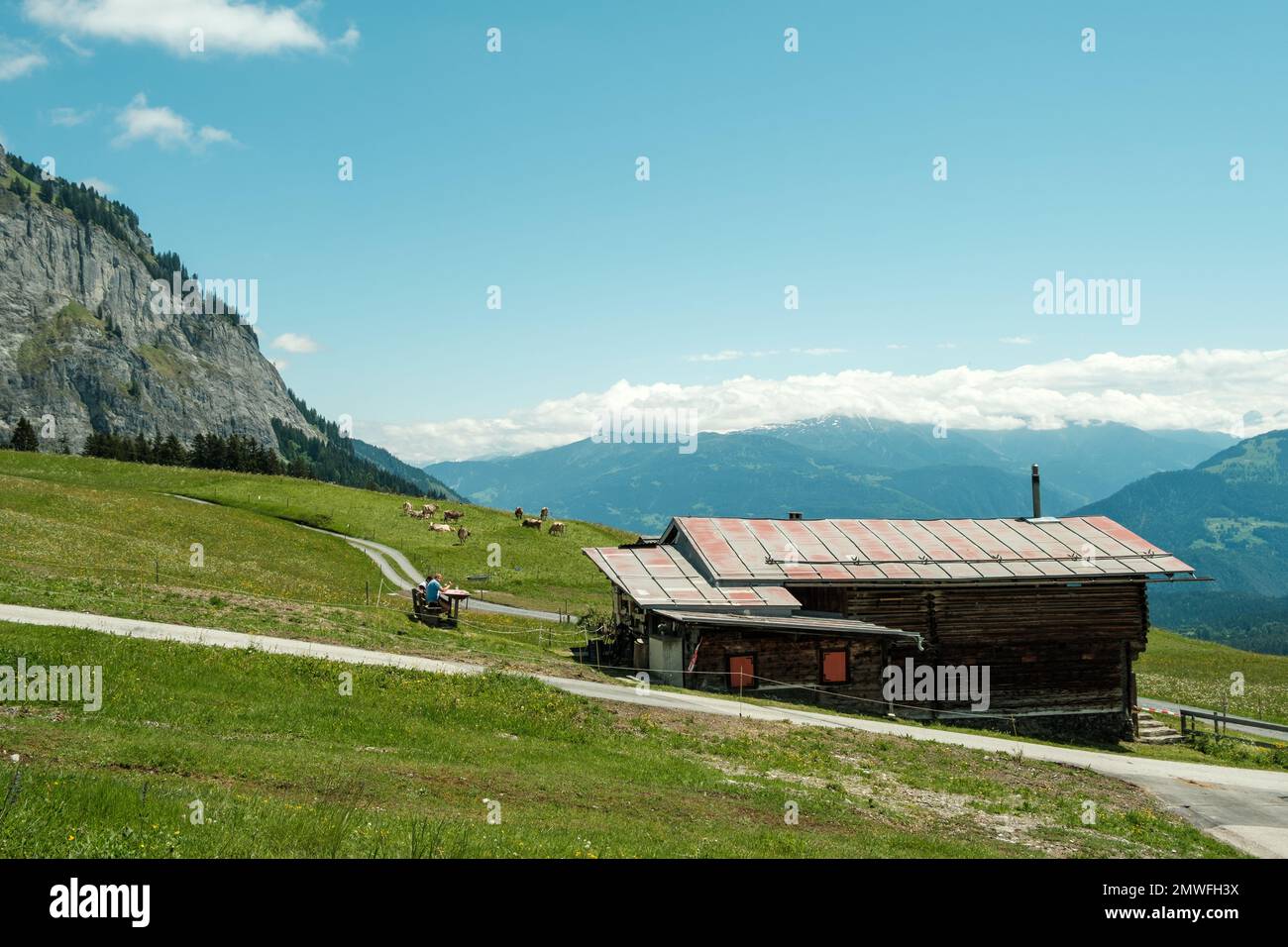 A wooden house in the mountains on a summer day in Flims, Grisons ...