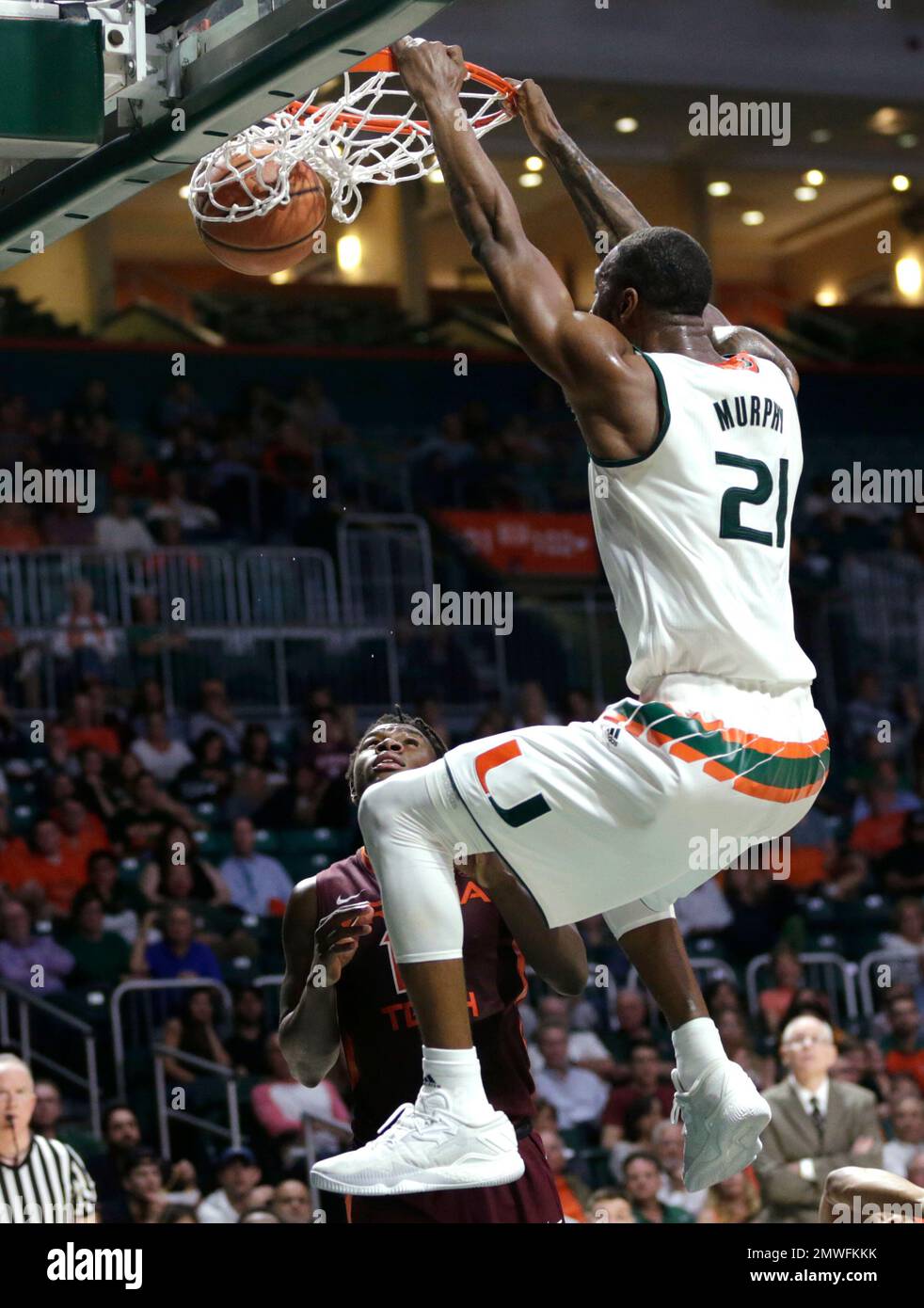 Miami's Kamari Murphy (21) dunks over Virginia Tech's Chris Clarke ...