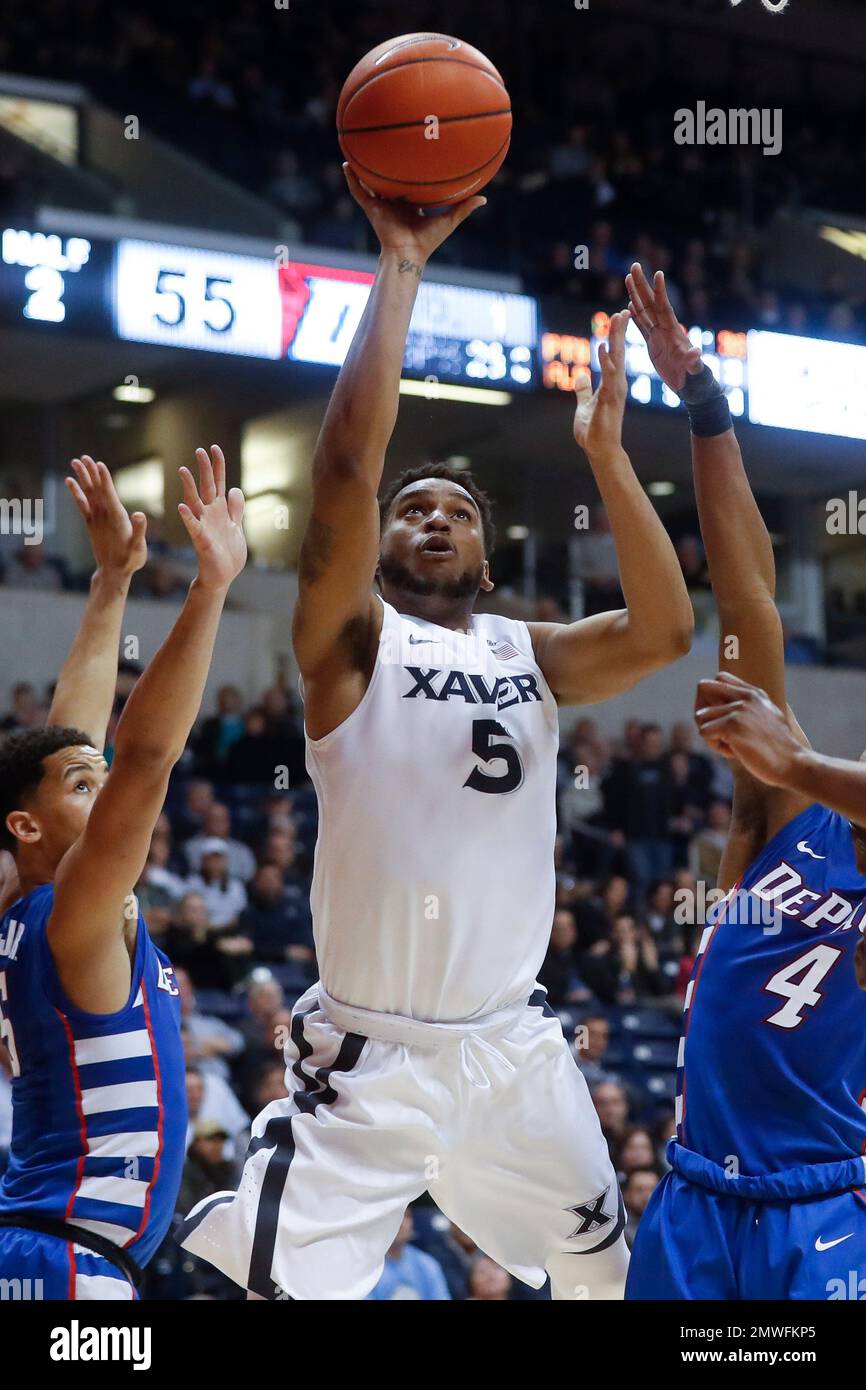 Xavier's Trevon Bluiett (5) shoots against DePaul's Billy Garrett Jr ...