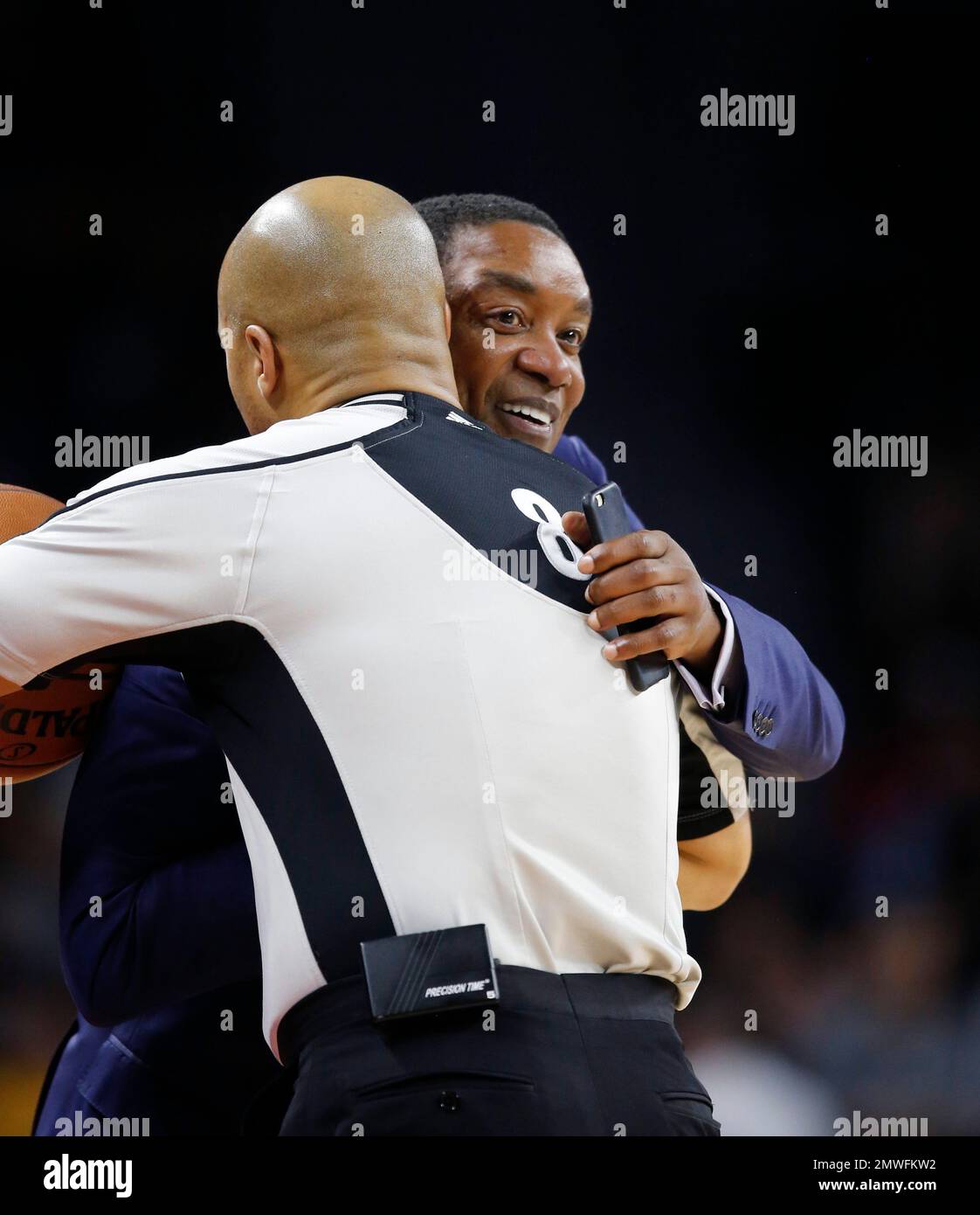 Former Detroit Pistons guard Isiah Thomas, hugs referee Marc Davis ...