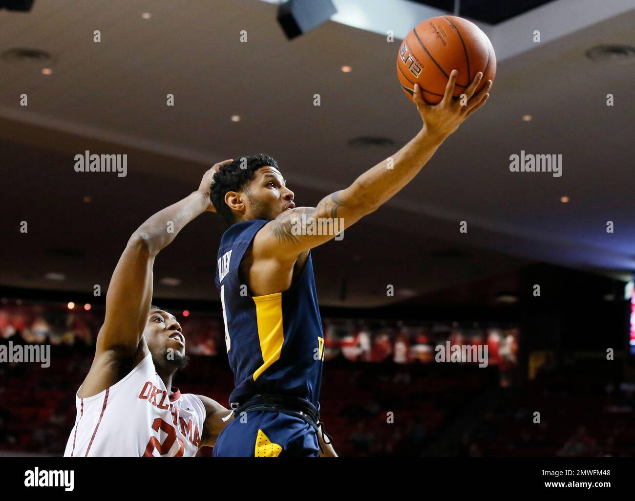 West Virginia guard James Bolden, right, shoots in front of Oklahoma ...