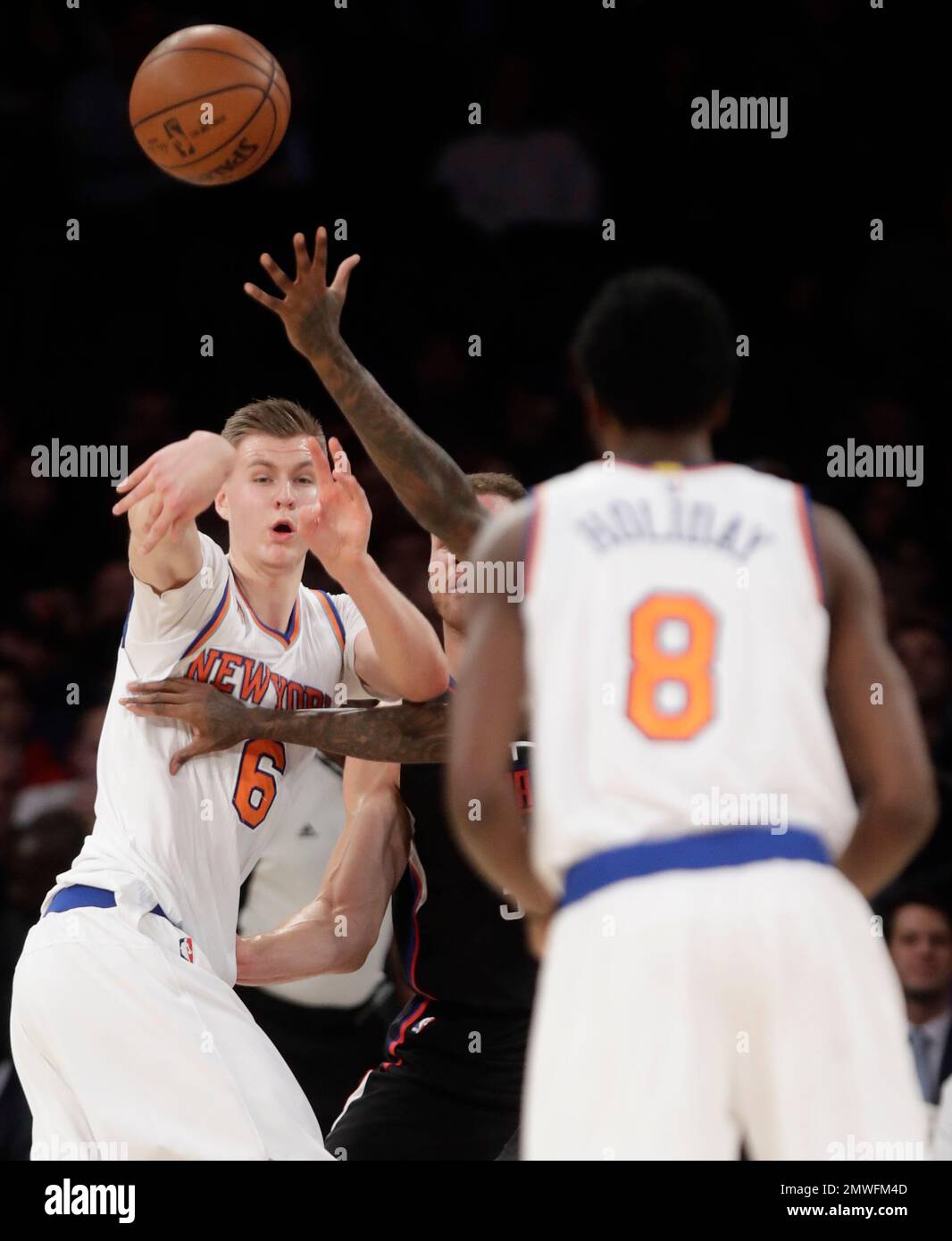 New York Knicks' Kristaps Porzingis (6) passes the ball to Justin ...