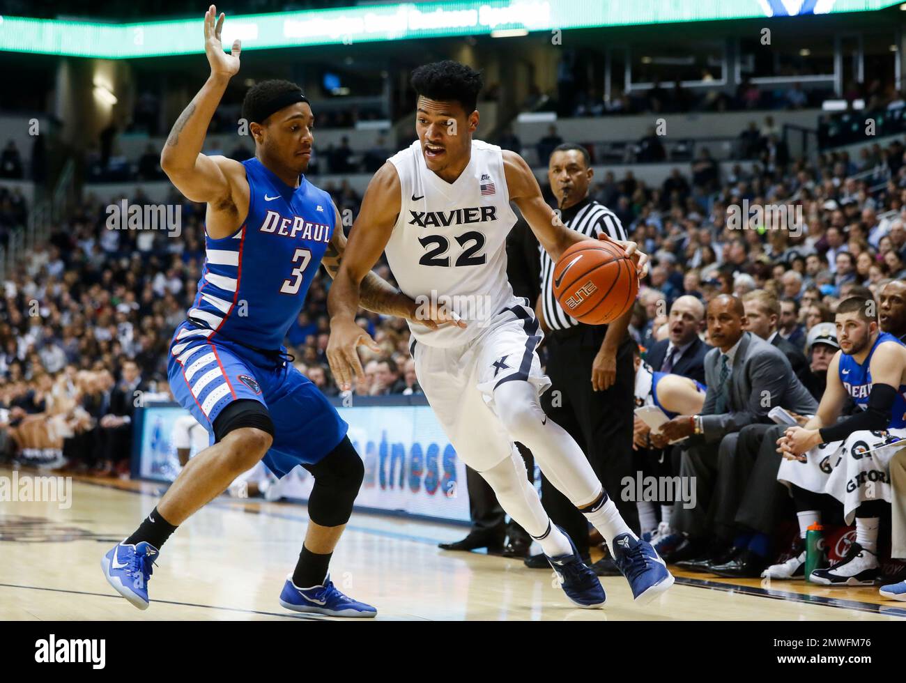 Xavier's Kaiser Gates (22) drives around DePaul's Devin Gage (3) during ...