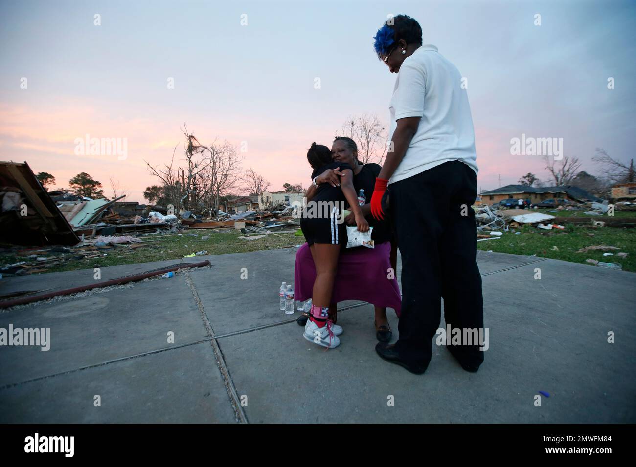 Thelma Packnett, seated, hugs her niece Kai Vincent, 7, outside her ...