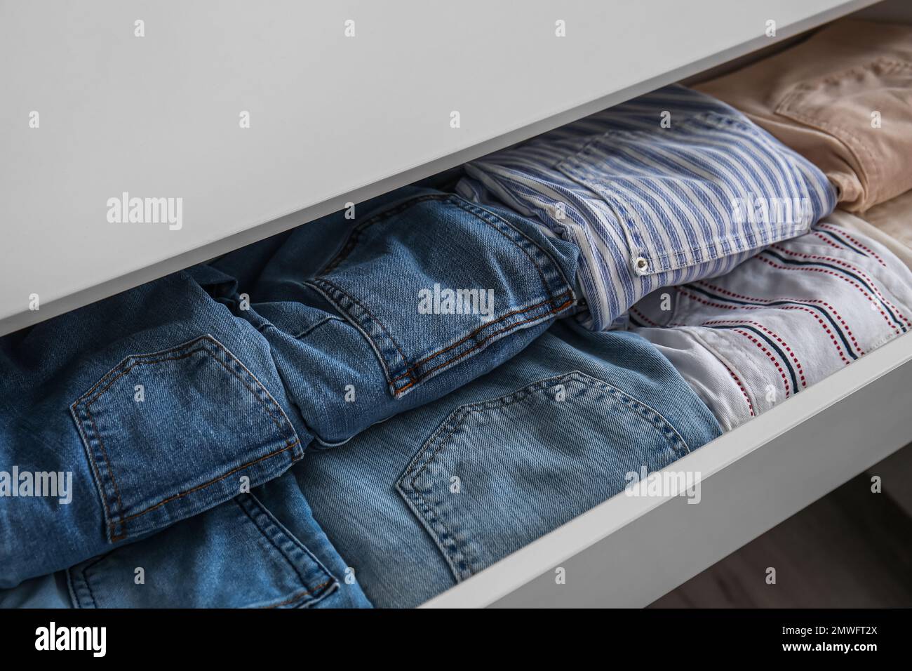Open drawer with folded clothes in room, closeup Stock Photo - Alamy