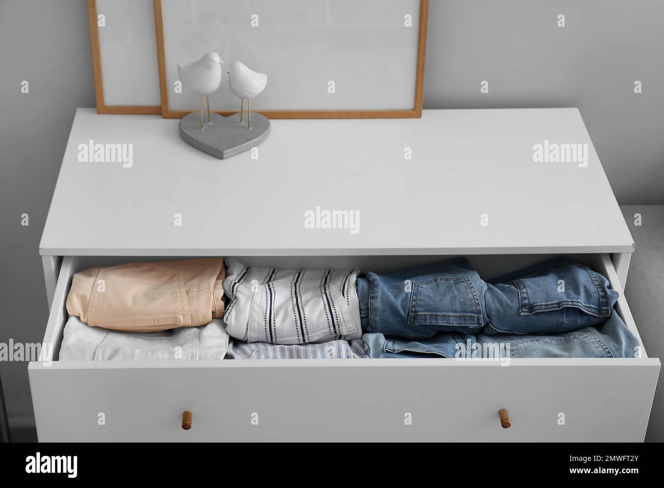 Open drawer with folded clothes in room, closeup Stock Photo - Alamy