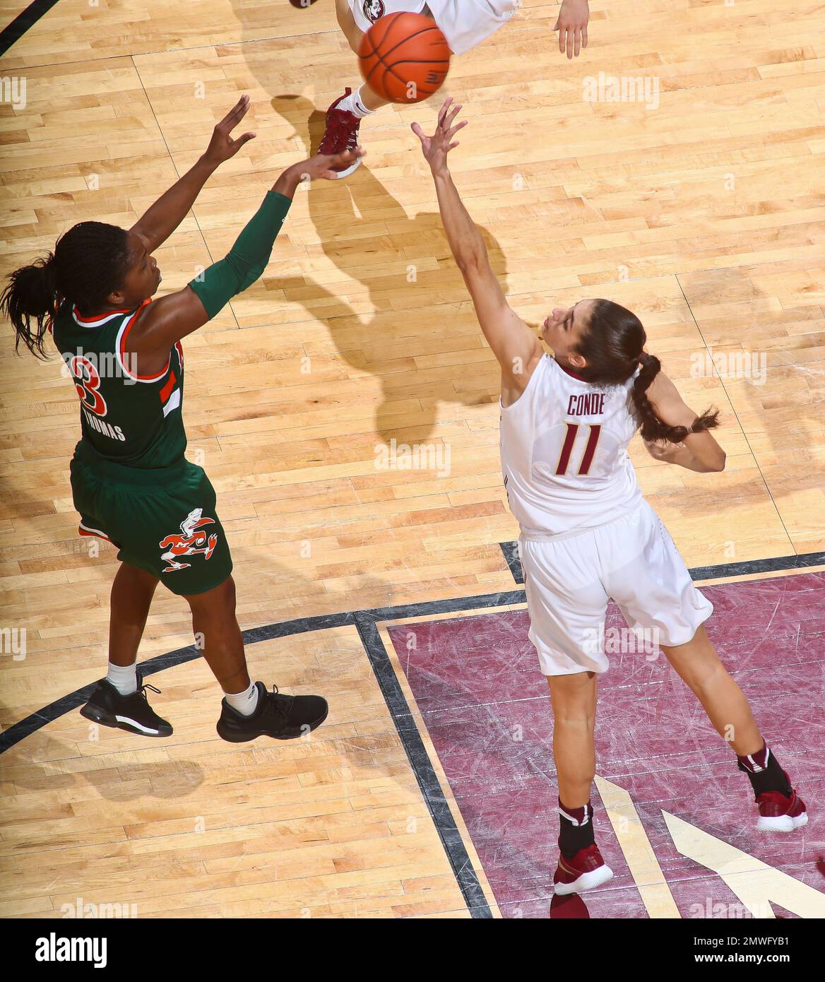 Miami guard Jessica Thomas (3) makes a basket over the defense of ...