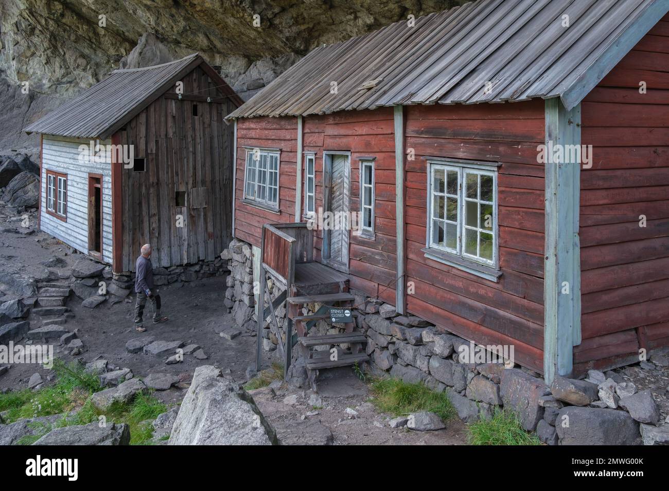 A group of people in front of wooden cottages under Helleren in ...