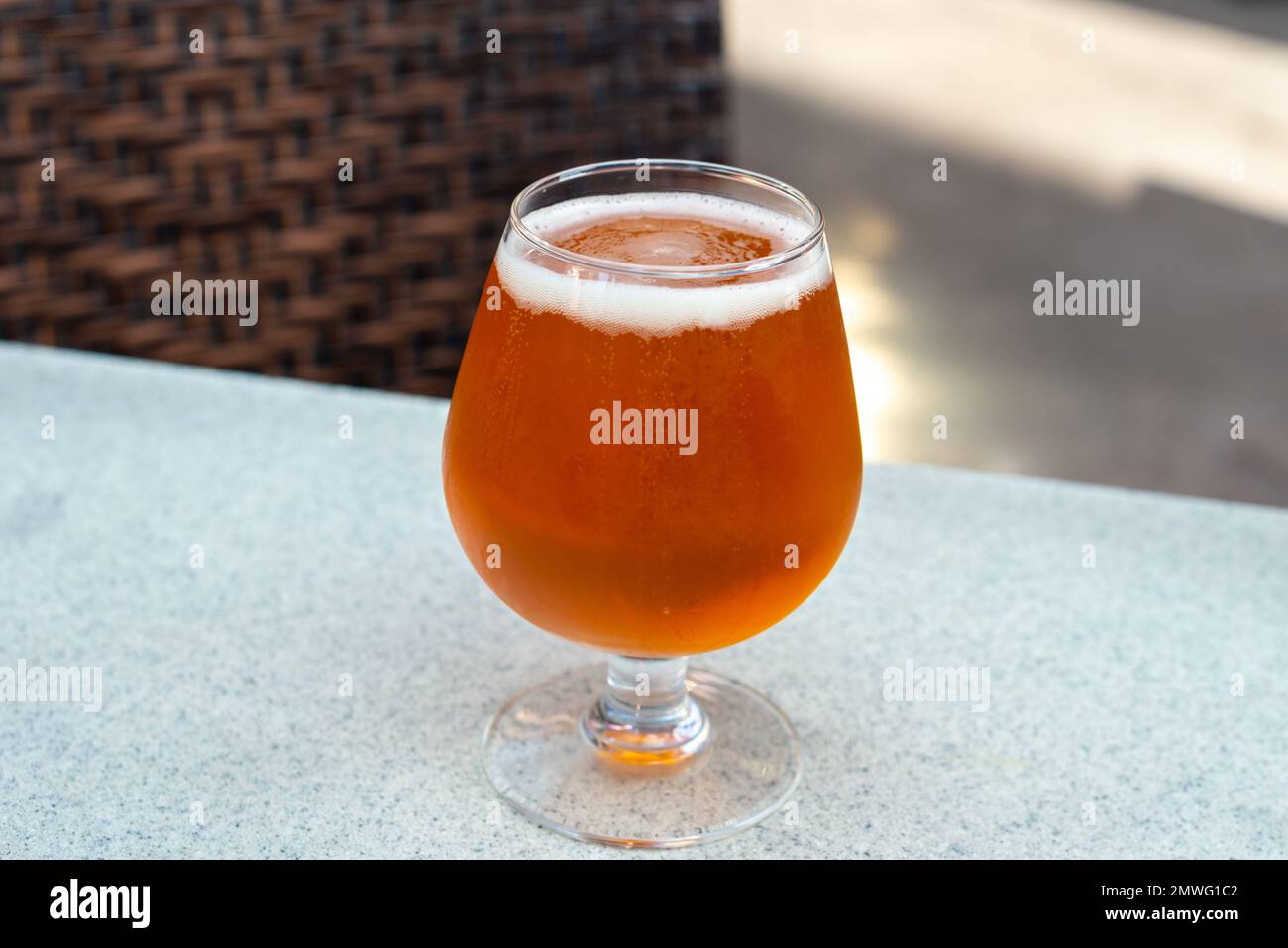 Top view of a glass of sour flavored beer with its head covered in ...