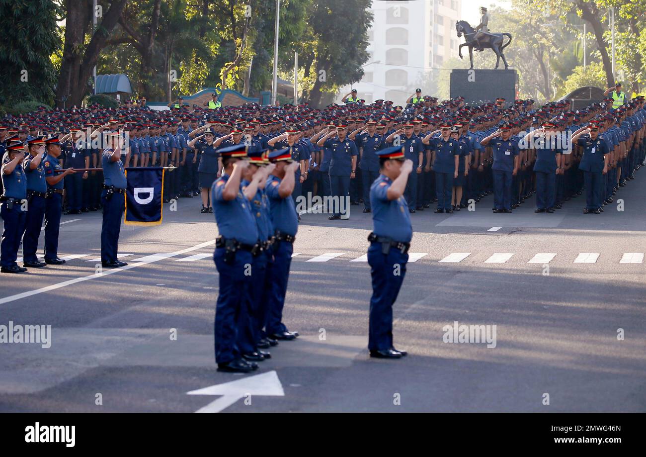 Members and officers of the Philippine National Police force salute ...