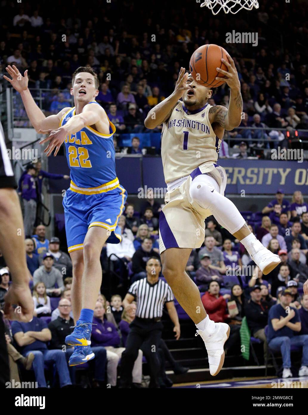 Washington's David Crisp (1) drives to the basket ahead of UCLA's TJ ...