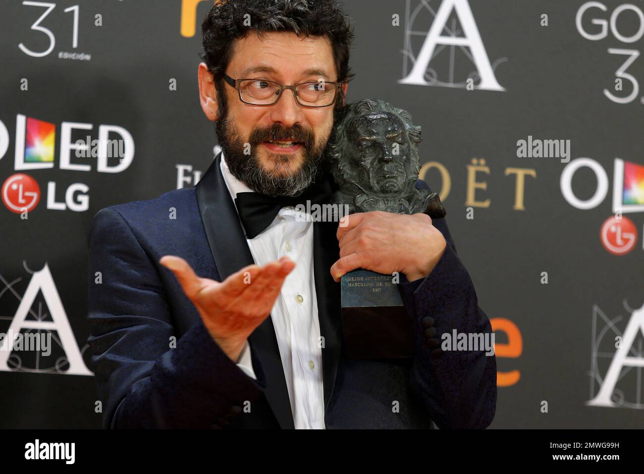 Spanish actor Manolo Solo poses with his trophy after winning the best ...