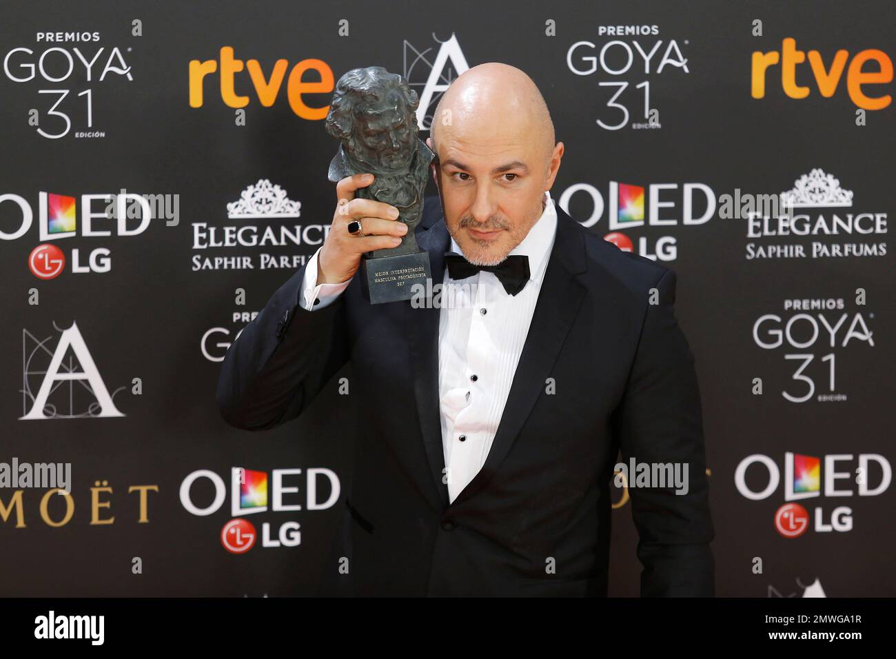 Spanish actor Roberto Alamo poses with his trophy after winning the ...