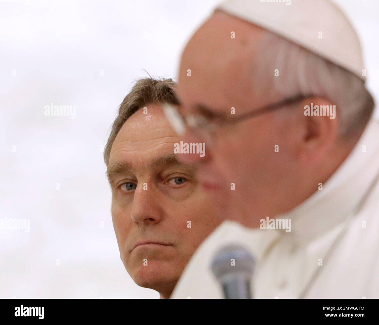 Archbishop Georg Gaenswein looks at Pope Francis delivering his message ...
