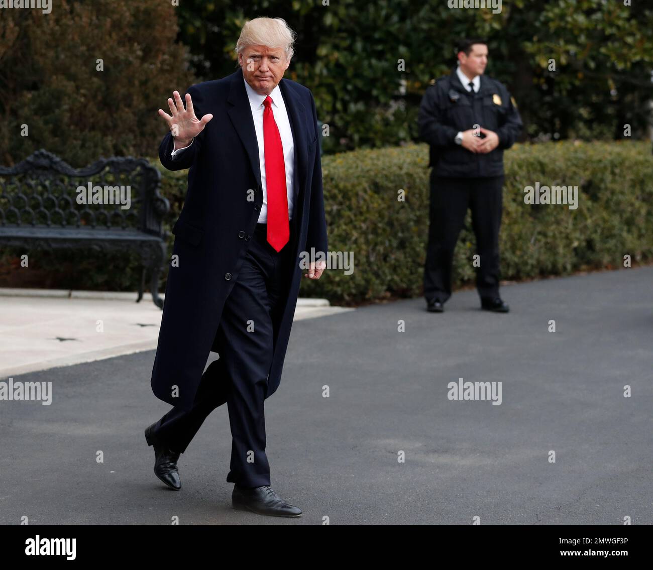 President Donald Trump waves as he walks from White House in Washington ...