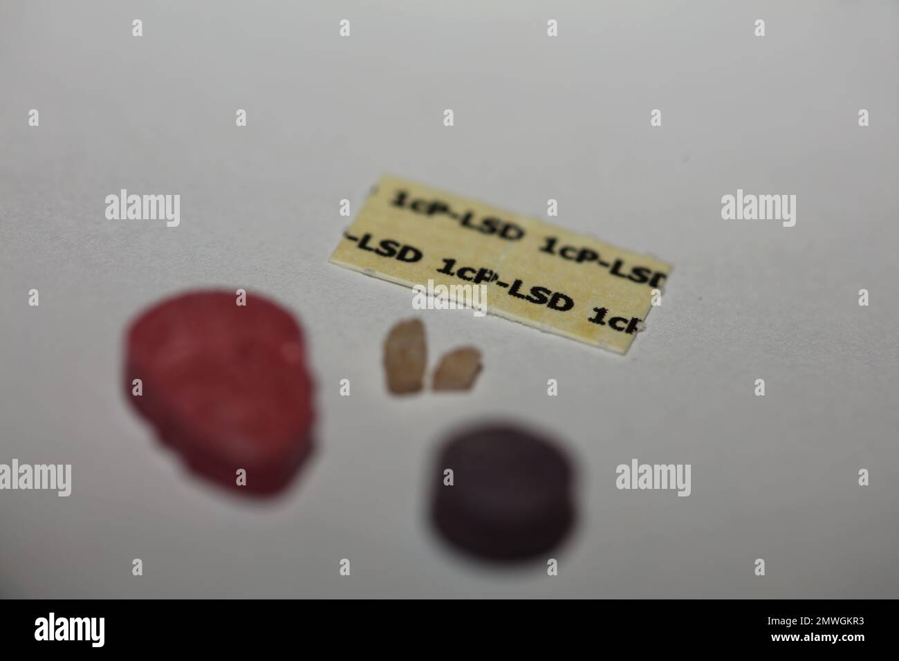 Close up on psychedelic set exstacy pills lsd papers and mdma small rocks doping background high ...