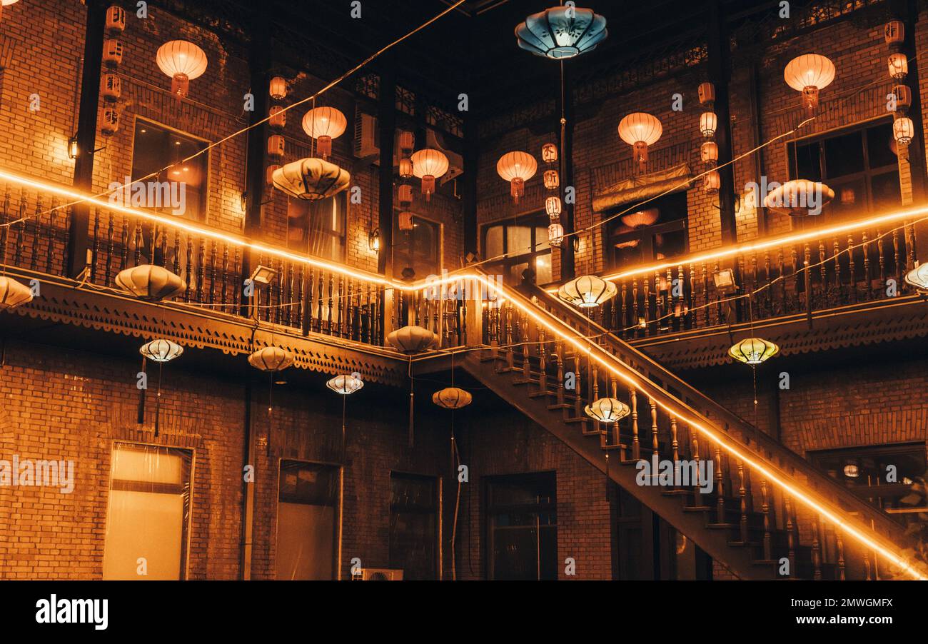 A Chinese restaurant with lanterns and stairs with bright light Stock ...
