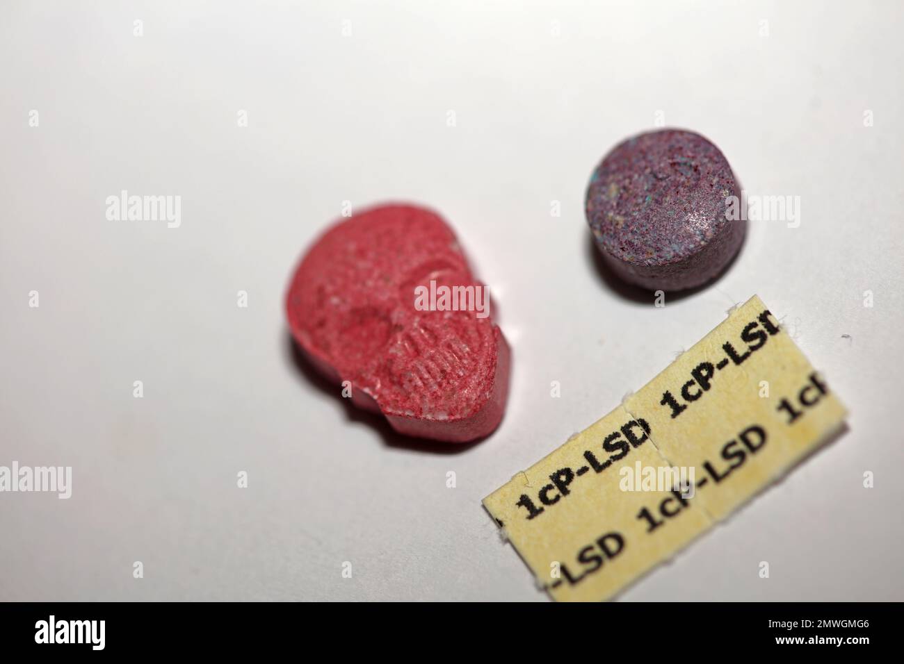 Close up on psychedelic set exstacy pills lsd papers and mdma small rocks doping background high ...