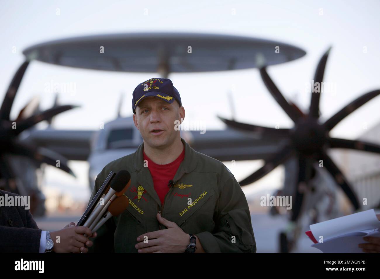 Cmdr. Daniel Prochazka, U.S. Navy Commanding Officer, center, talks to ...