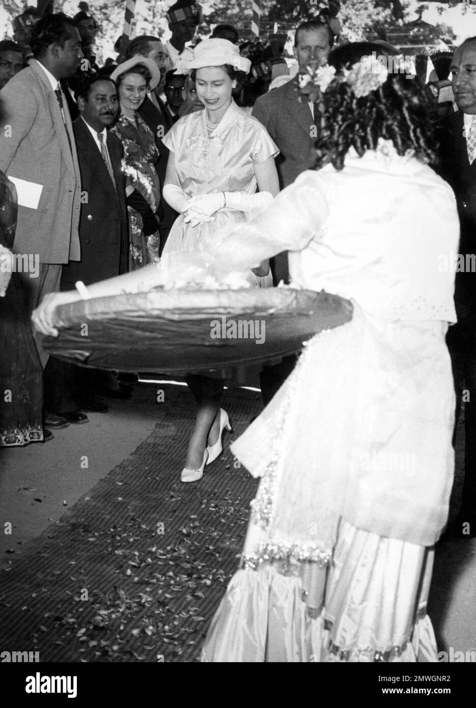 Queen Elizabeth II steps on a path strewn with rose petals during a ...