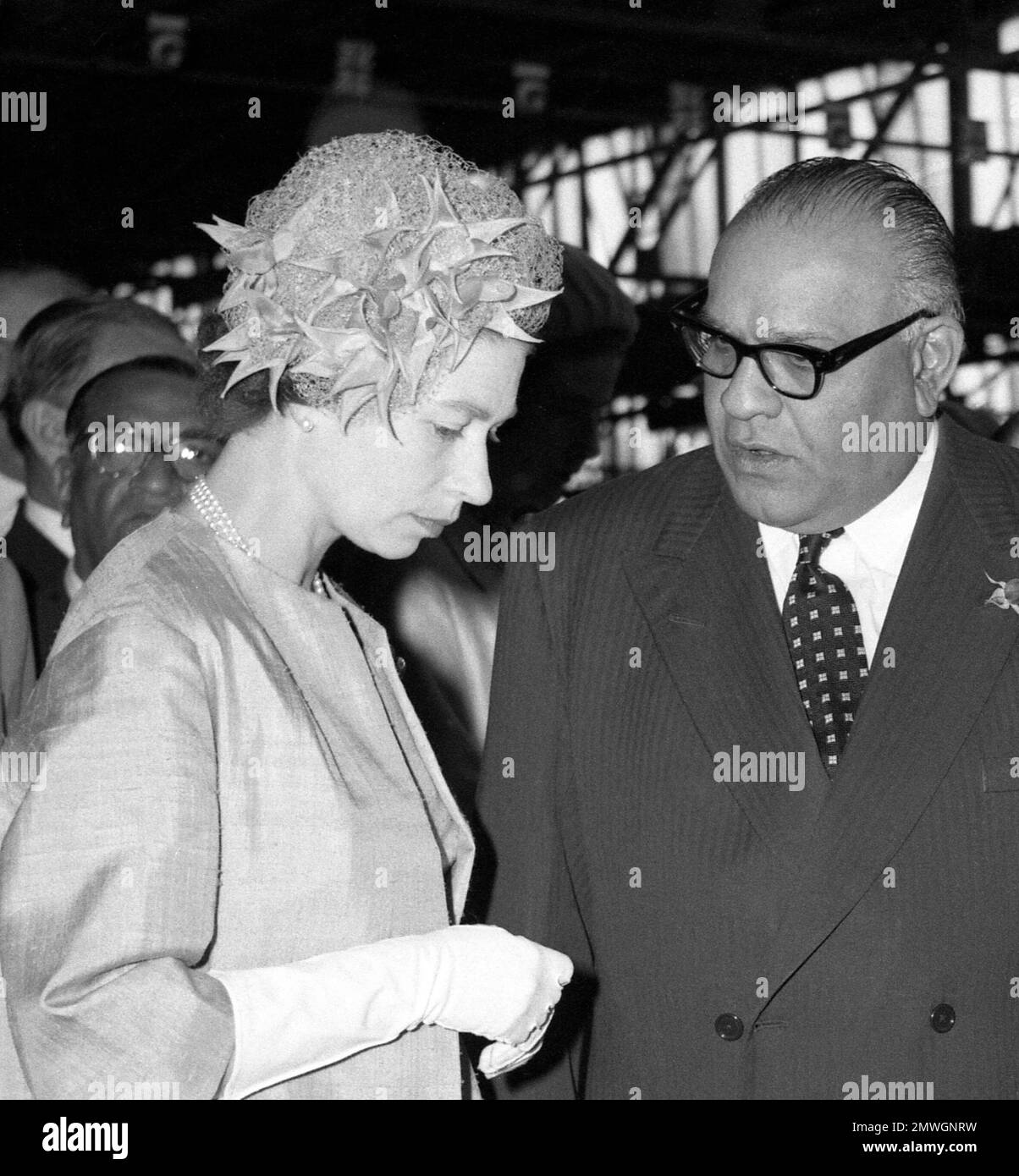 Queen Elizabeth II wore this unusual head-hugging hat trimmed with ...