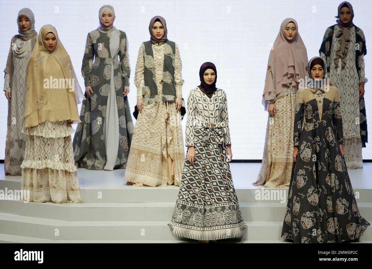 Models strike a pose on the runway wearing creations by designer Lia ...