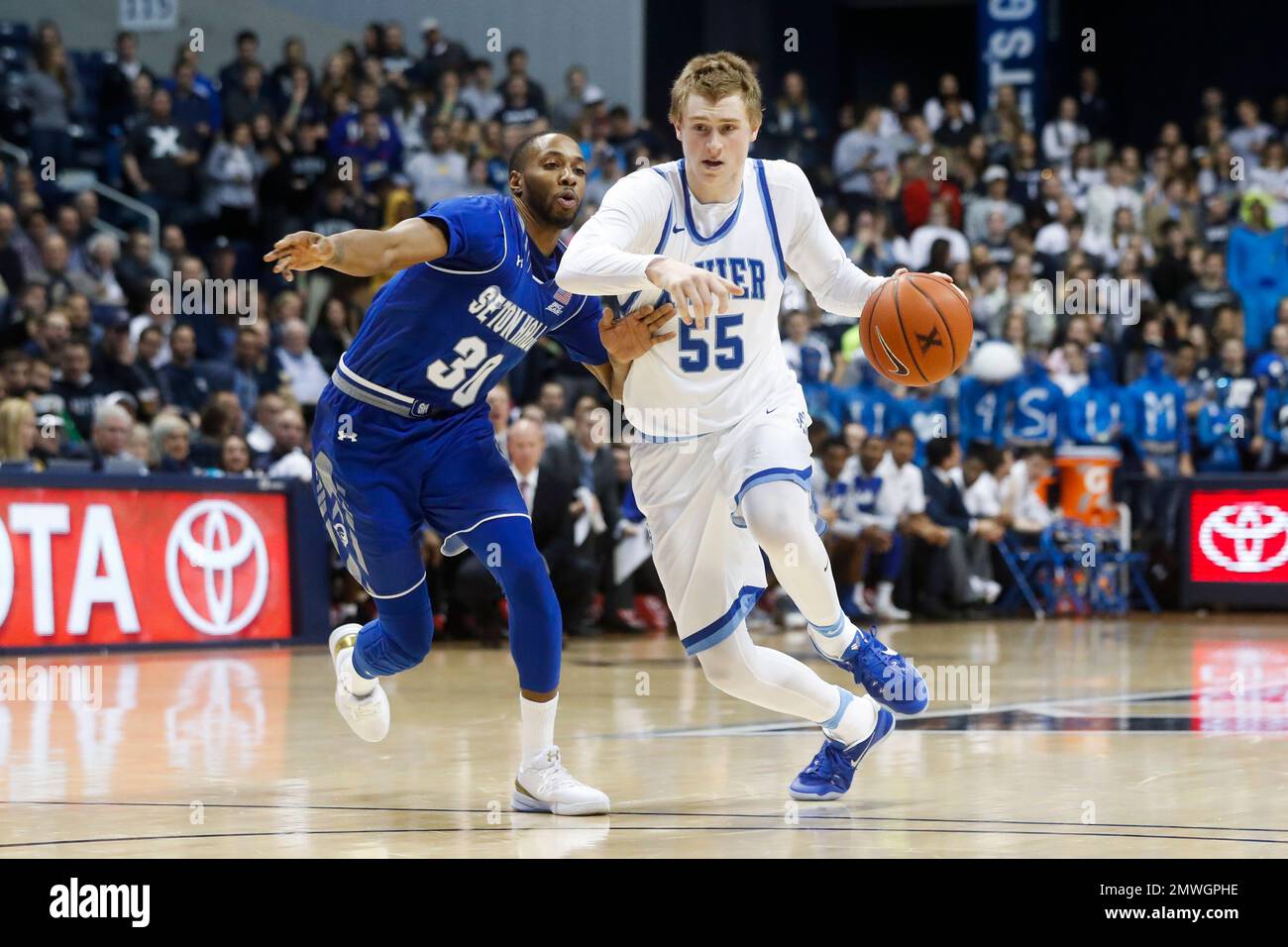 Xavier's J.P. Macura (55) drives around Seton Hall's Madison Jones (30 ...