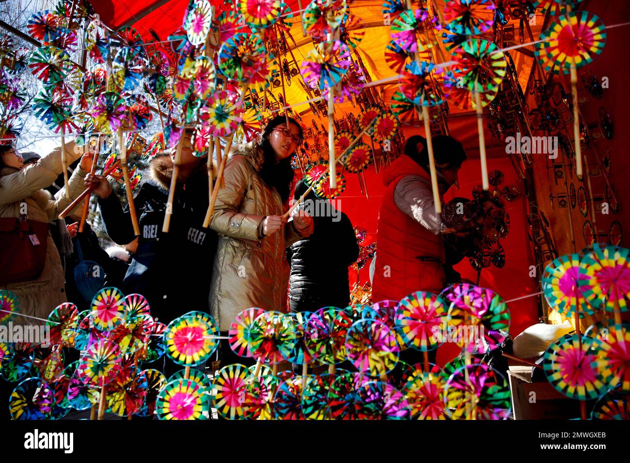 Visitors to a temple fair select Chinese-made colorful pinwheels on ...