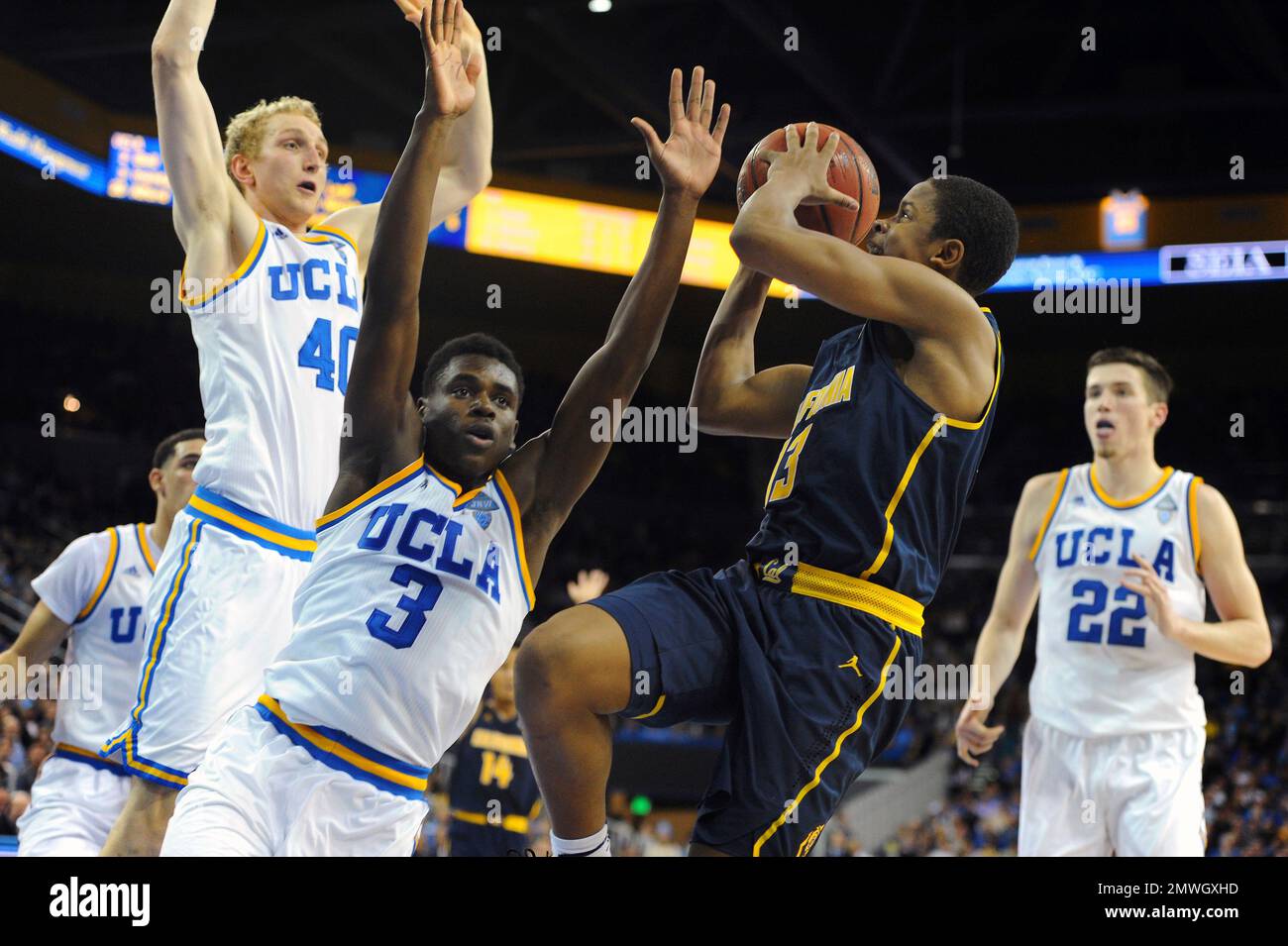 California guard Charlie Moore (13) shoots against UCLA's Thomas Welsh ...
