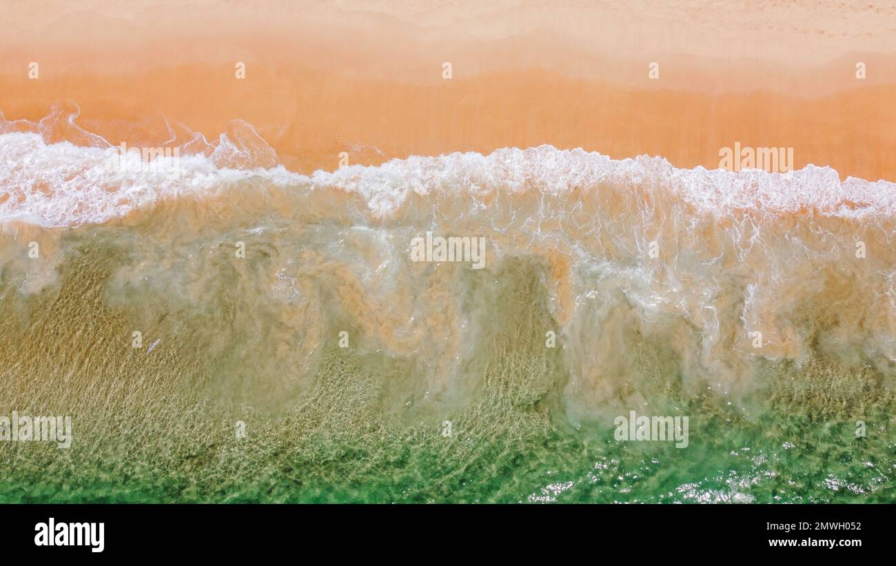 An aerial top view of a beach washed by the waters of a sea ...