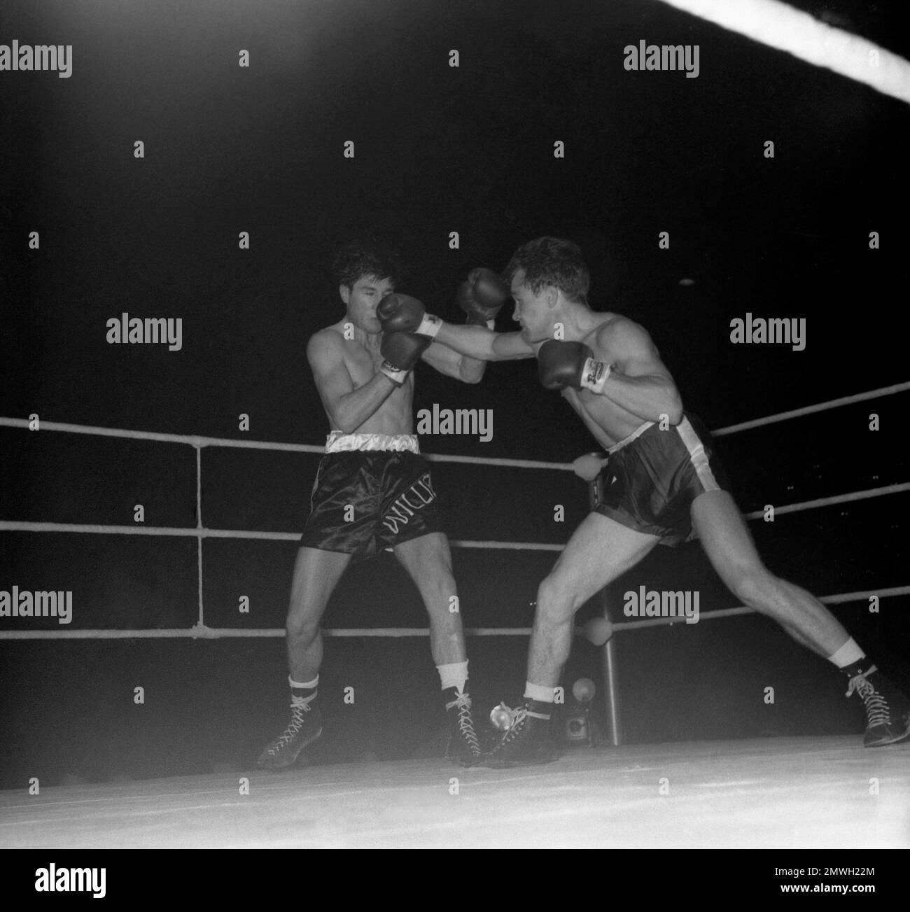 Dave Charnley of Dartford, right, swings a right and lifts the hair of ...
