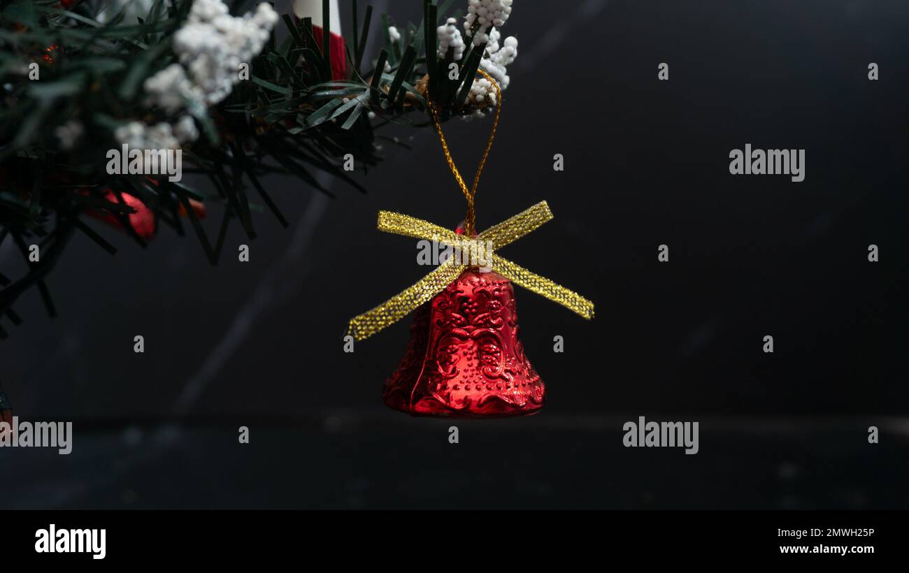 A Christmas bell hanging from pine tree Stock Photo - Alamy