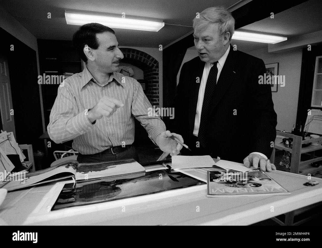 Harry Summers, editor of Vietnam Magazine, talks over layout with ...