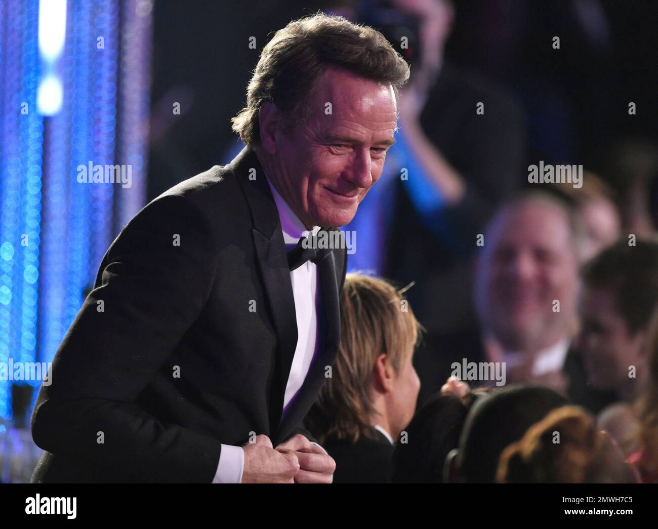 Bryan Cranston leaves his seat to accept the award for outstanding ...