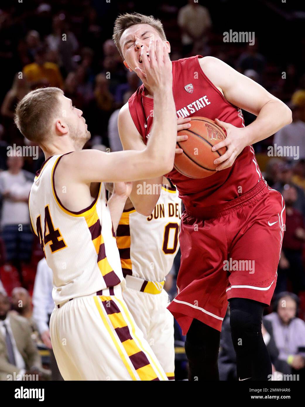 Washington State forward Josh Hawkinson (24) pulls down a rebound as ...