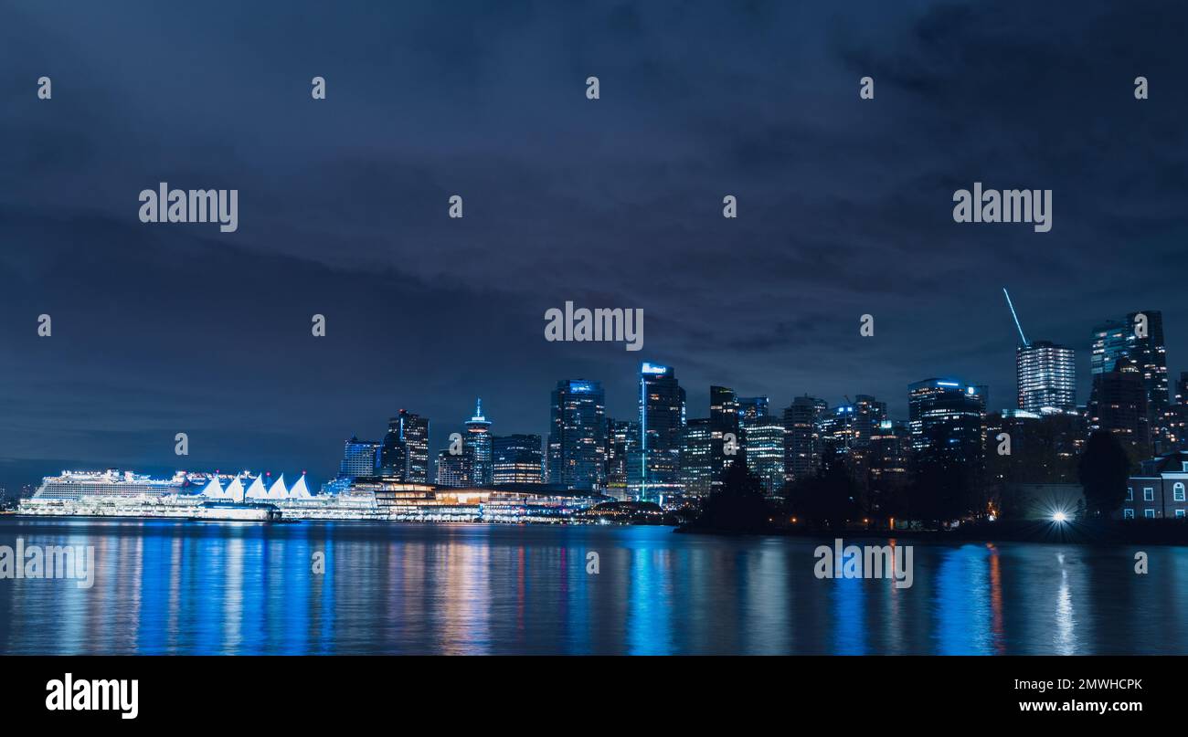 An aerial view of cityscape Vancouver surrounded by buildings and water ...
