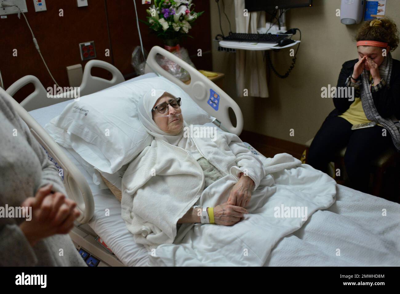 Nour Ulayyet left, comforts her mother Isaaf Jamal Eddin, while ...