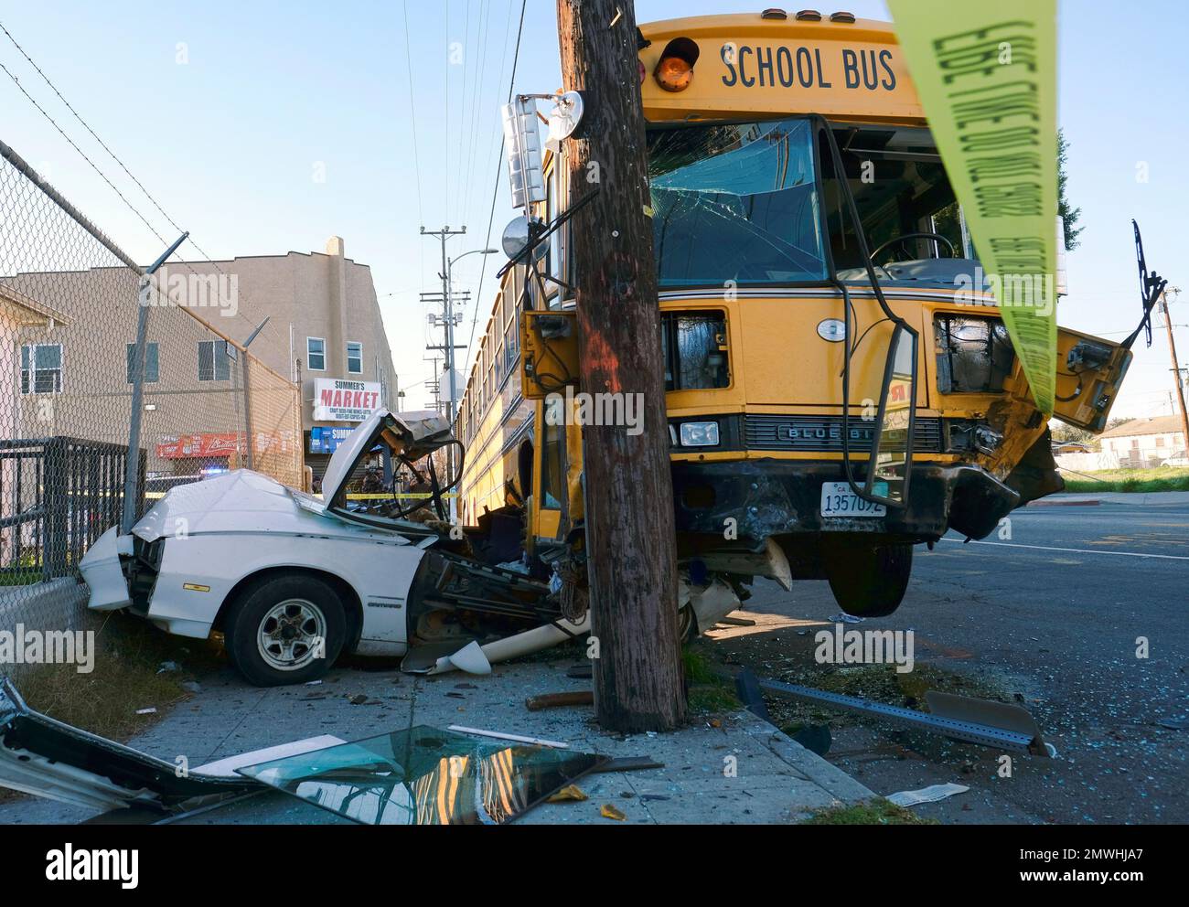 A car is wedged under a school bus after a chain reaction that crashed ...