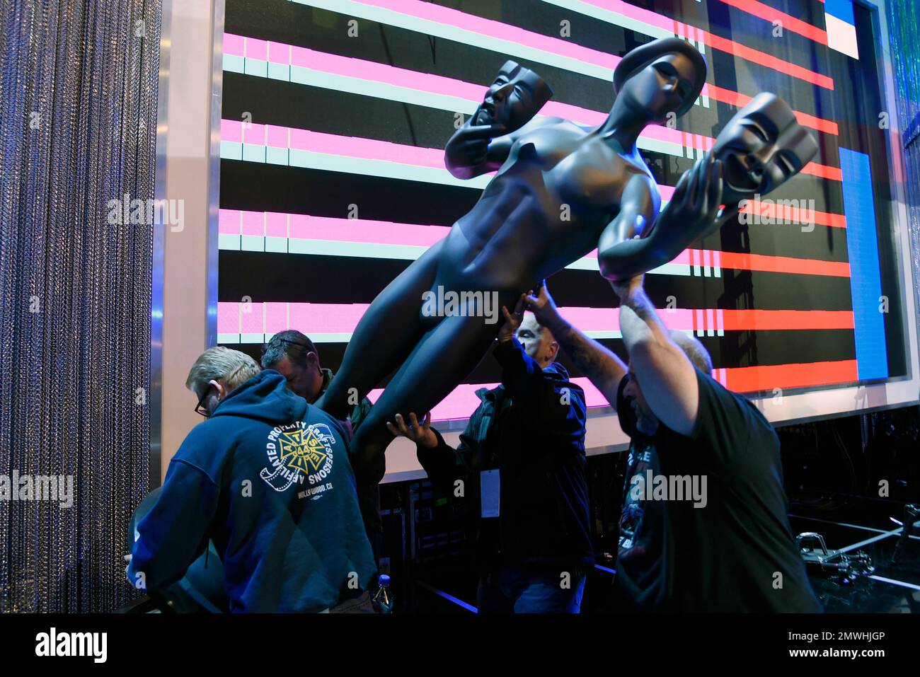 Crew members install a Screen Actors Guild "Actor" statue onstage for ...